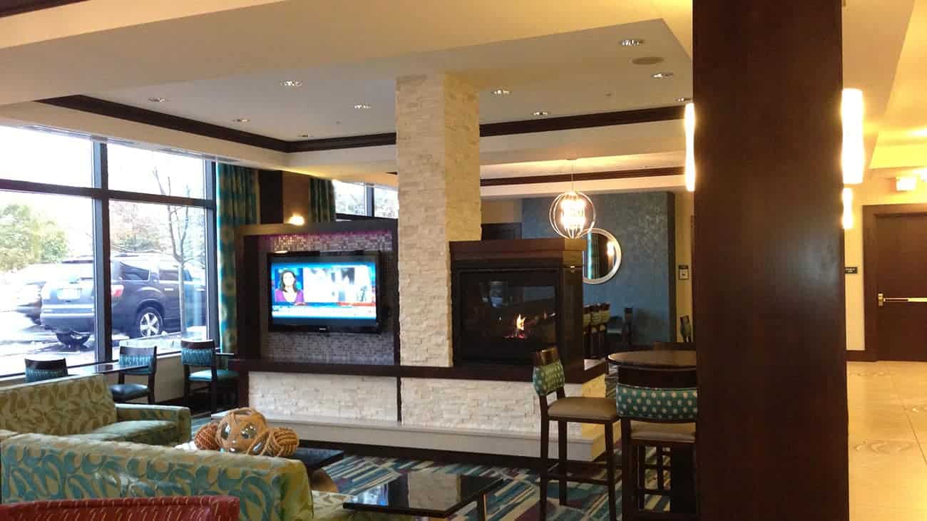 Arctic White Hilton Hotel Lobby Fireplace - Realstone Systems